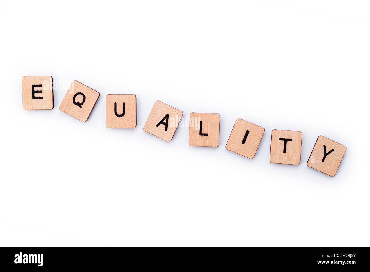 The word EQUALITY, spelt with wooden letter tiles over a white ...