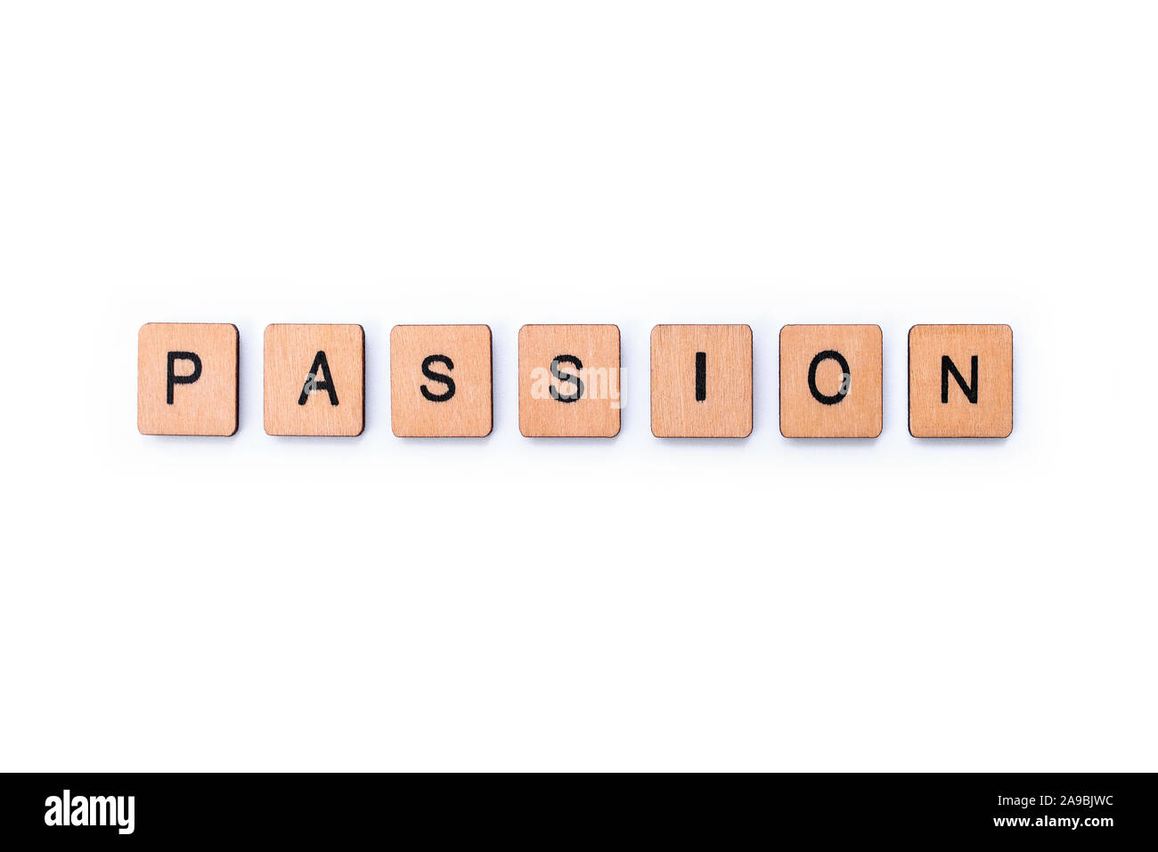 The word PASSION, spelt with wooden letter tiles over a white ...
