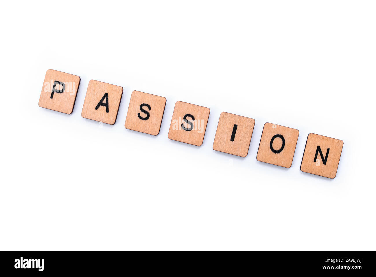The word PASSION, spelt with wooden letter tiles over a white ...