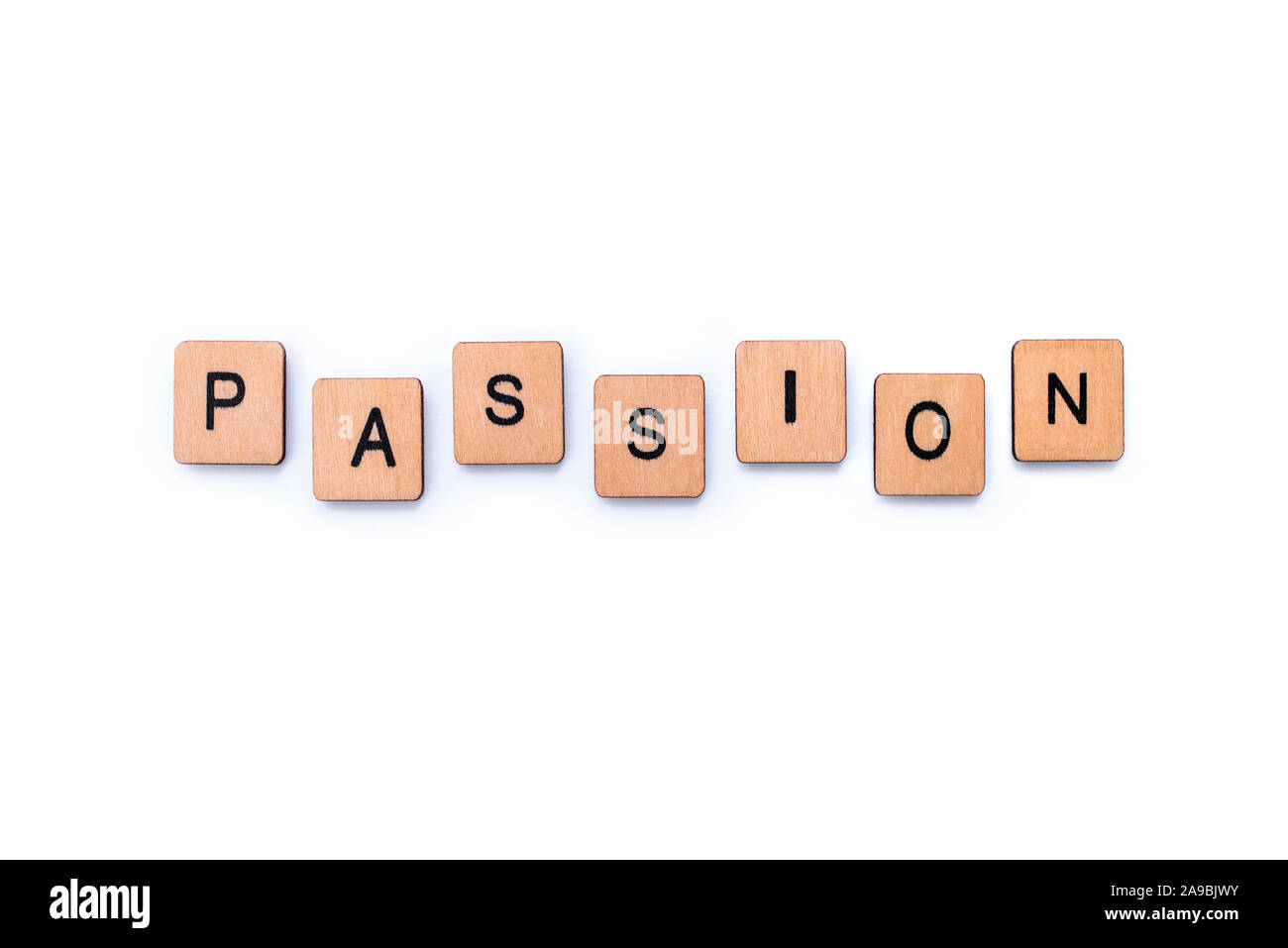 The word PASSION, spelt with wooden letter tiles over a white ...