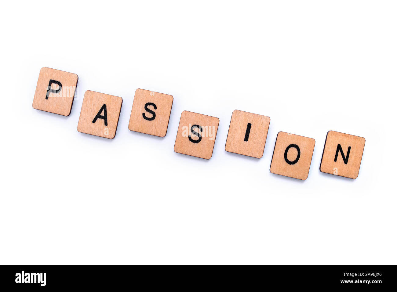 The word PASSION, spelt with wooden letter tiles over a white ...