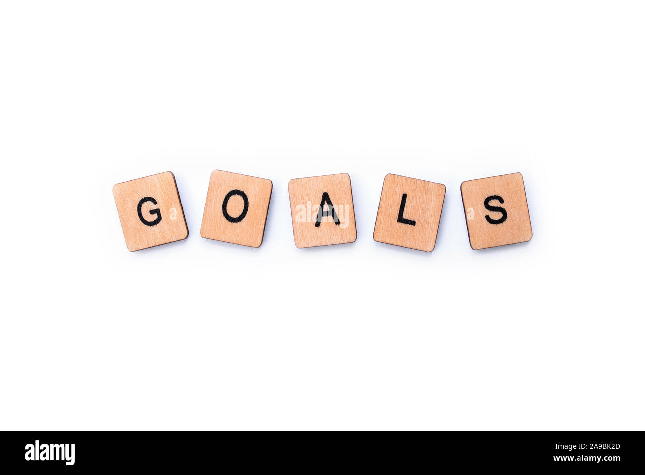 The word GOALS, spelt with wooden letter tiles over a white background ...