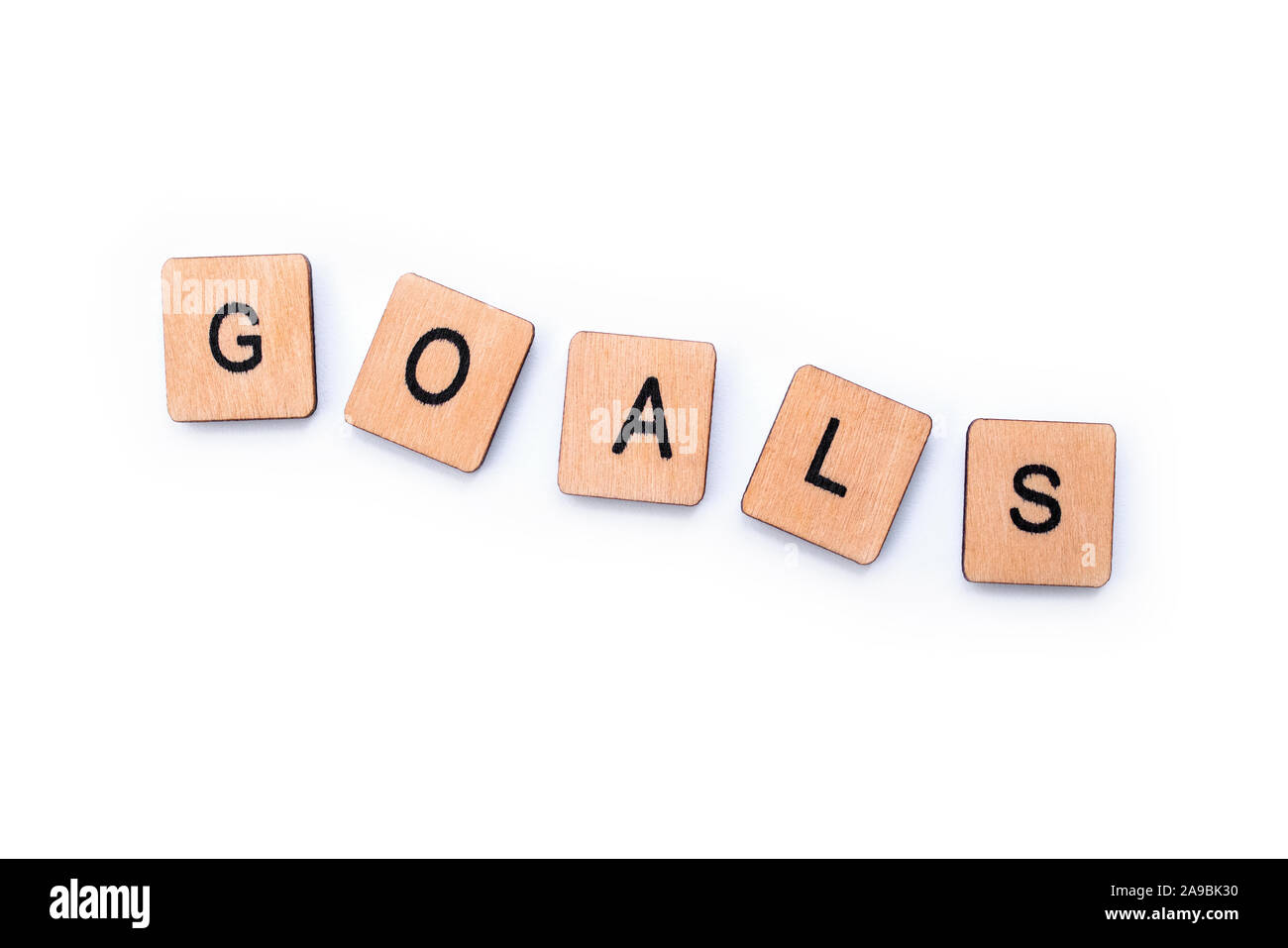 The word GOALS, spelt with wooden letter tiles over a white background ...