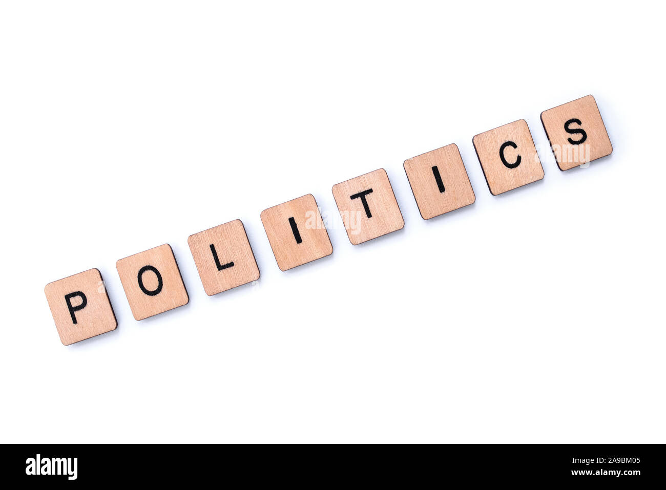 The word POLITICS, spelt with wooden letter tiles on a white background ...
