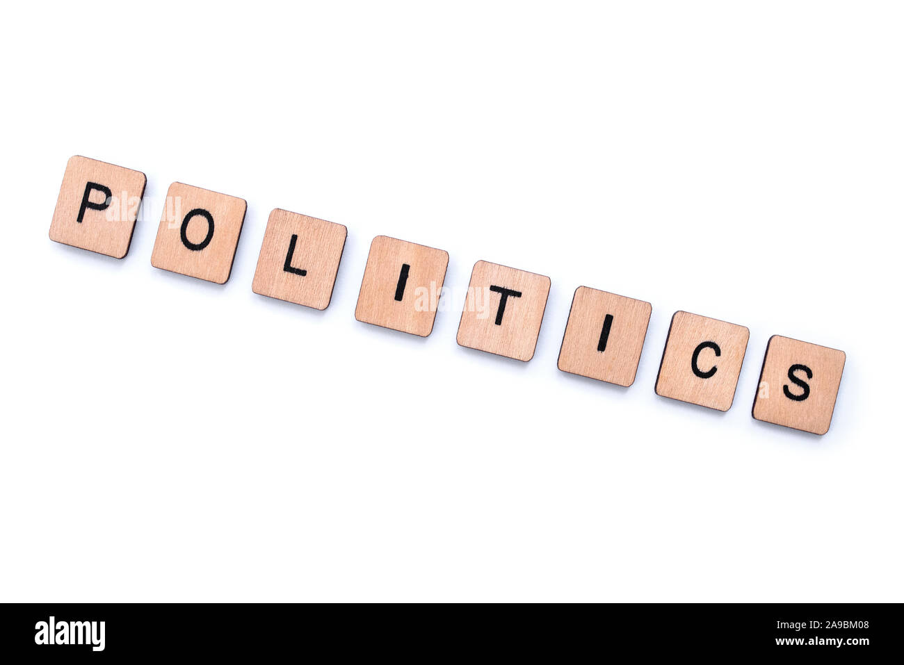 The word POLITICS, spelt with wooden letter tiles on a white background ...