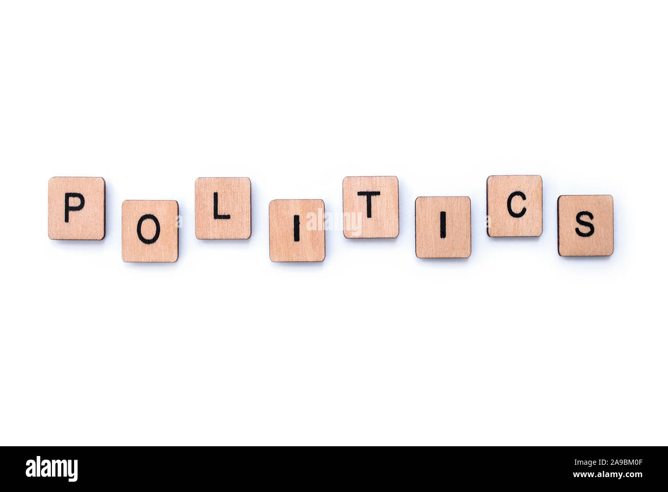 The word POLITICS, spelt with wooden letter tiles on a white background ...