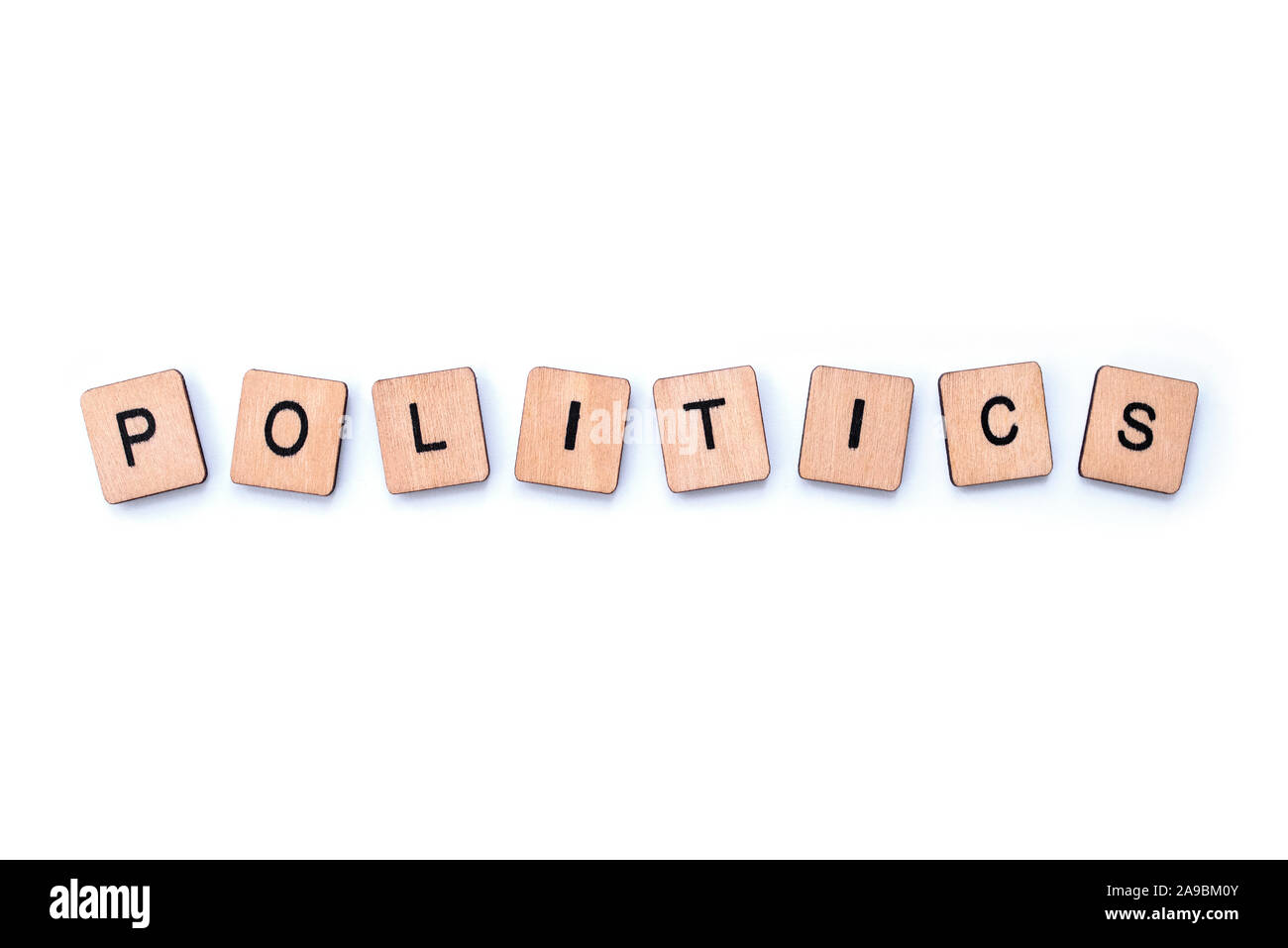 The word POLITICS, spelt with wooden letter tiles on a white background ...