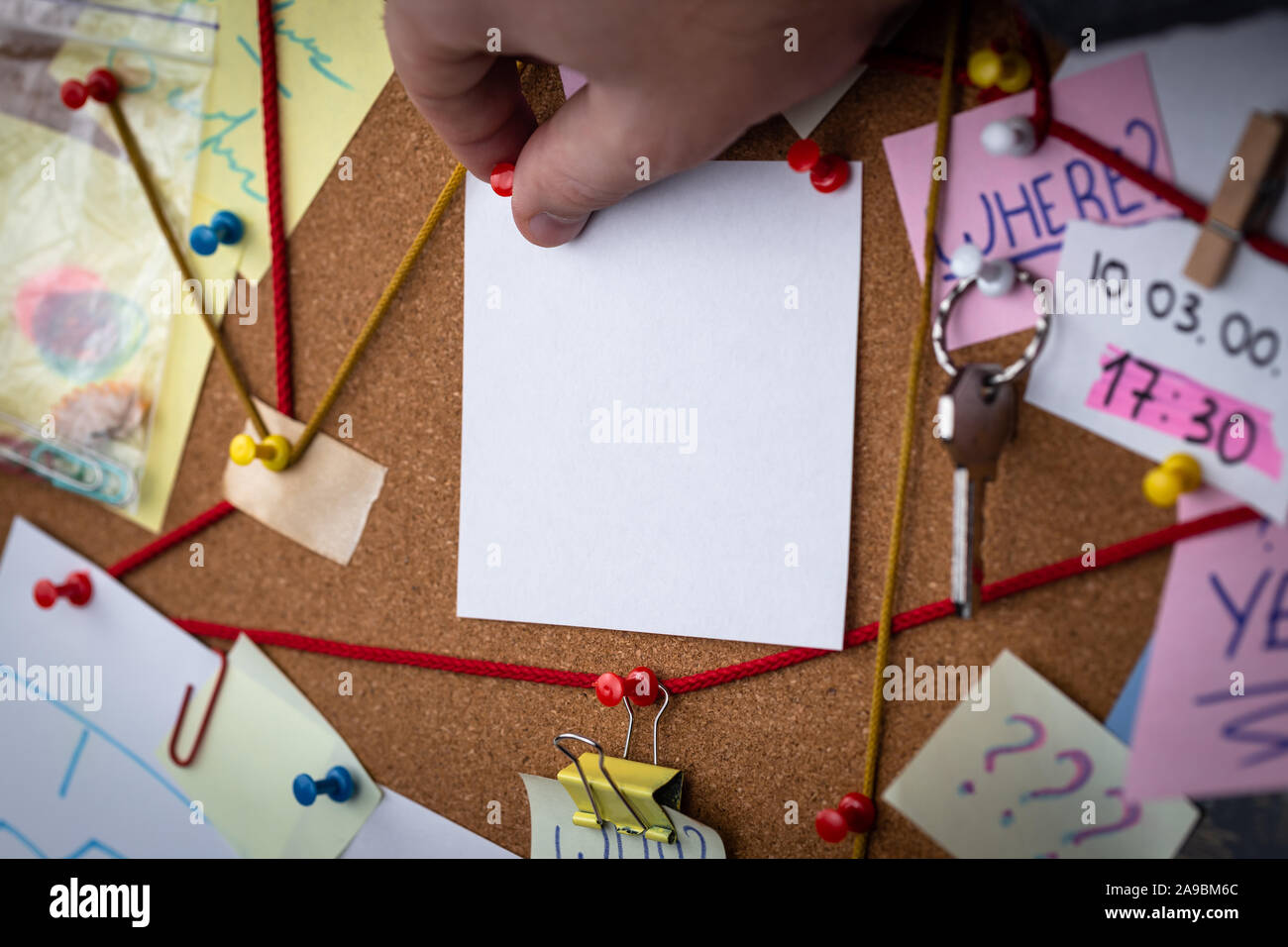 search concept. Close-up view of a detective board with evidence. In ...