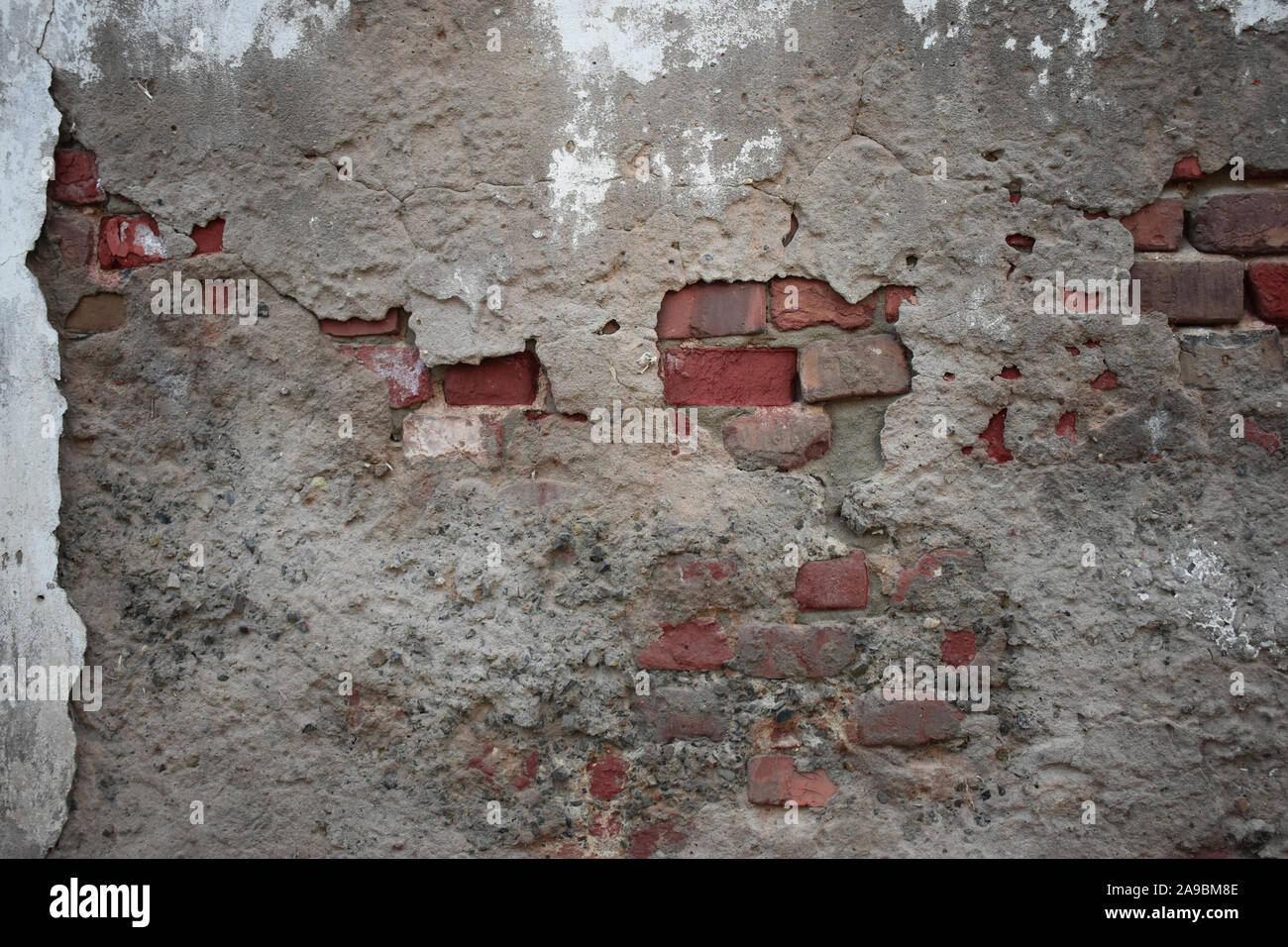 Old ruined wall with sticking out fragments of bricks and cement Stock ...
