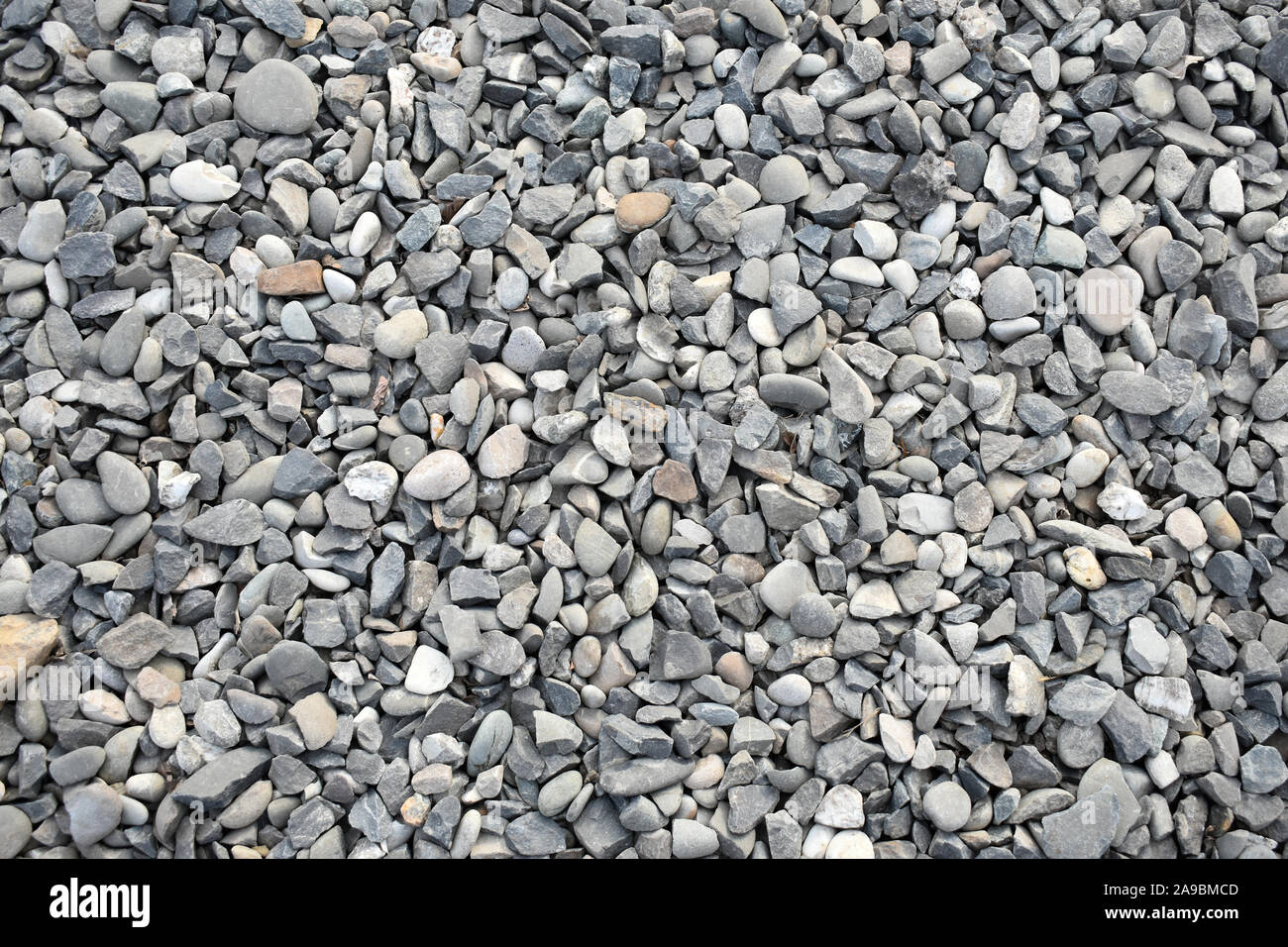 Gravel background with small and medium size stones various colors ...