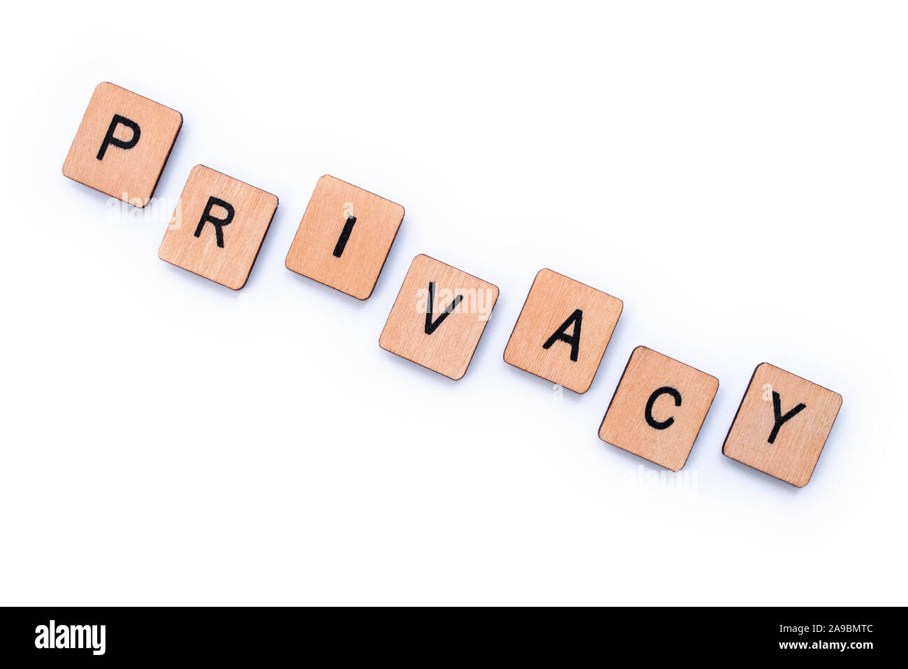 The word PRIVACY, spelt with wooden letter tiles over a white ...