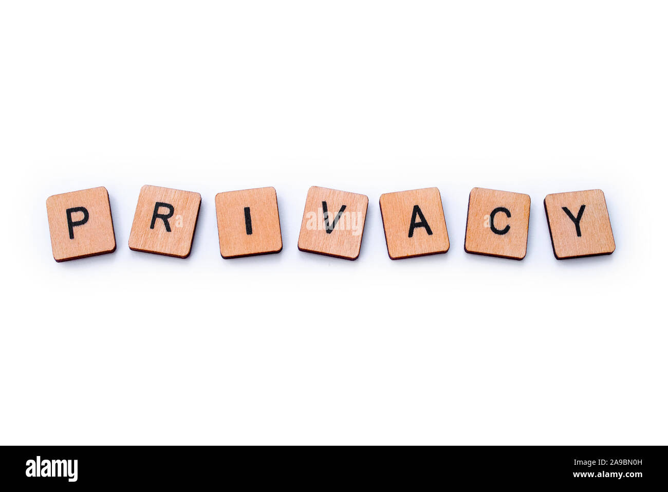 The word PRIVACY, spelt with wooden letter tiles over a white ...