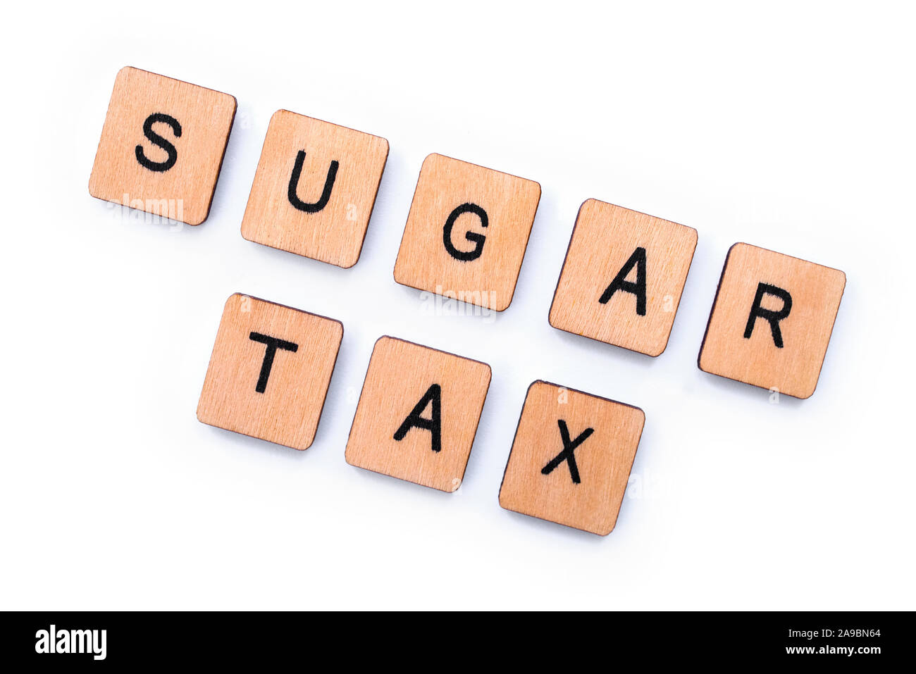 SUGAR TAX, spelt with wooden letter tiles over a white background Stock ...