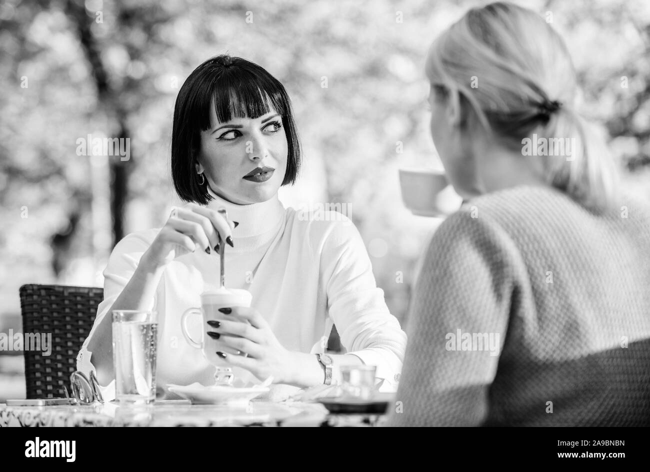 Girls friends drink coffee talk. Conversation women cafe terrace ...
