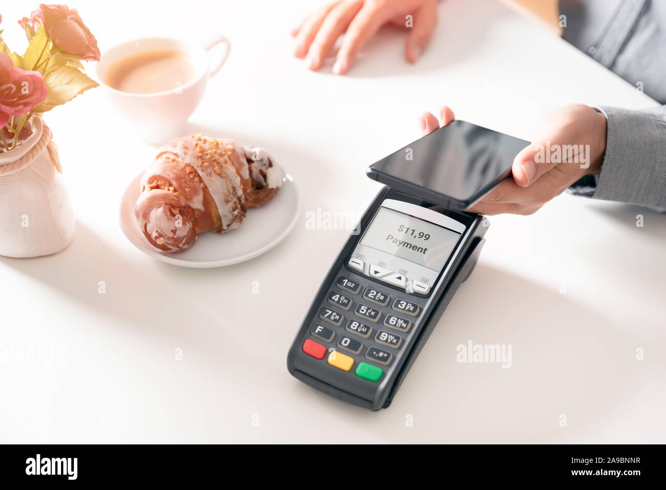 Man using smart phone to pay in restaurant. NFC contactless convenient ...