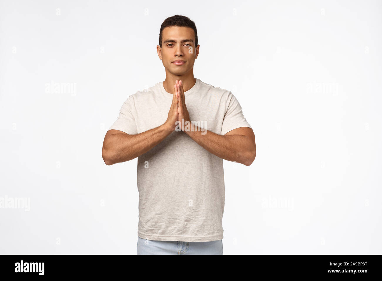 Peaceful good-looking strong, athletic young man in casual t-shirt ...