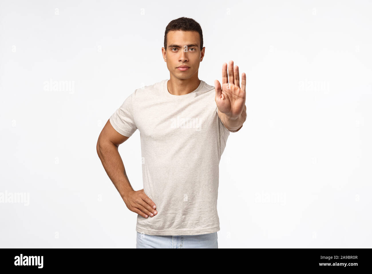 Strong handsome security guy pulling hand in stop motion, look ...