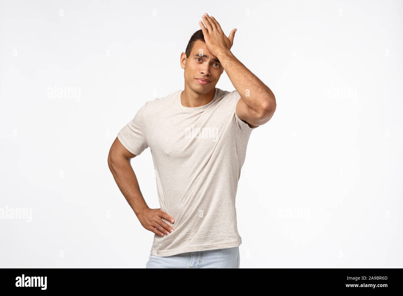 Upset and disappointed gloomy handsome guy in casual t-shirt, punch ...