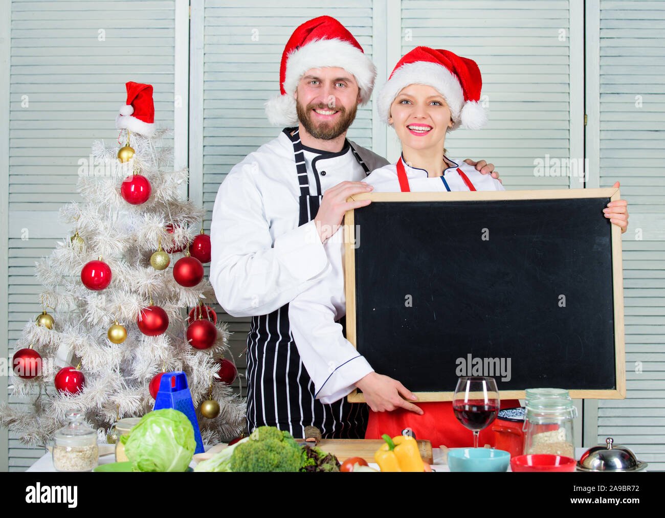 Cooking christmas meal. Man and woman chef santa hat near christmas ...