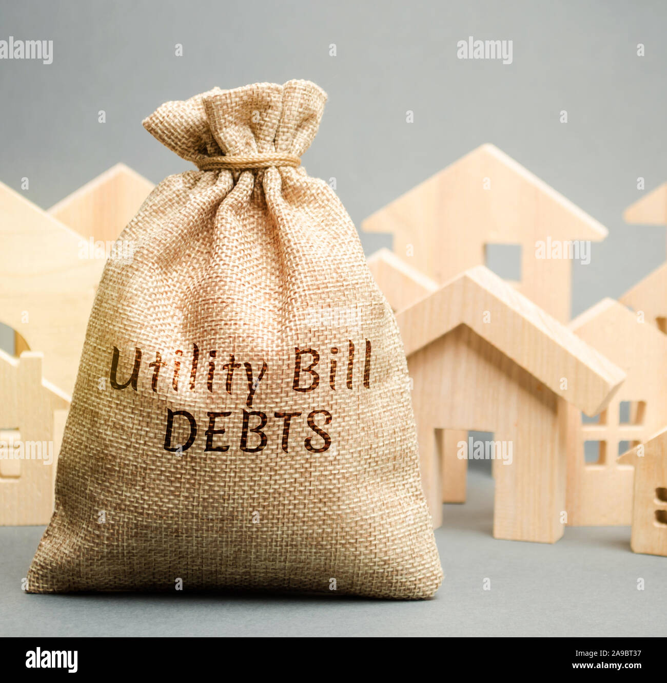 Money bag with the words Utility bill debts and wooden houses. Fines ...