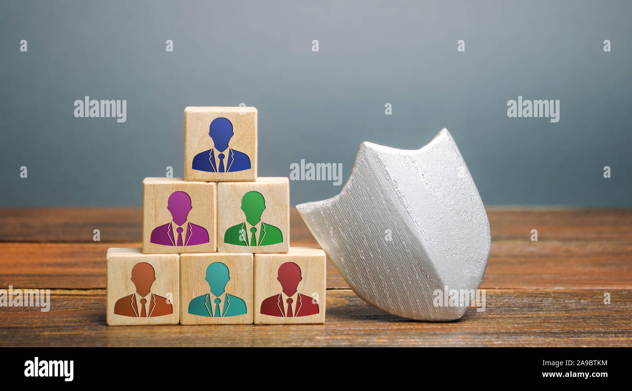 Wooden blocks with the image of a team of workers and a shield. Working ...