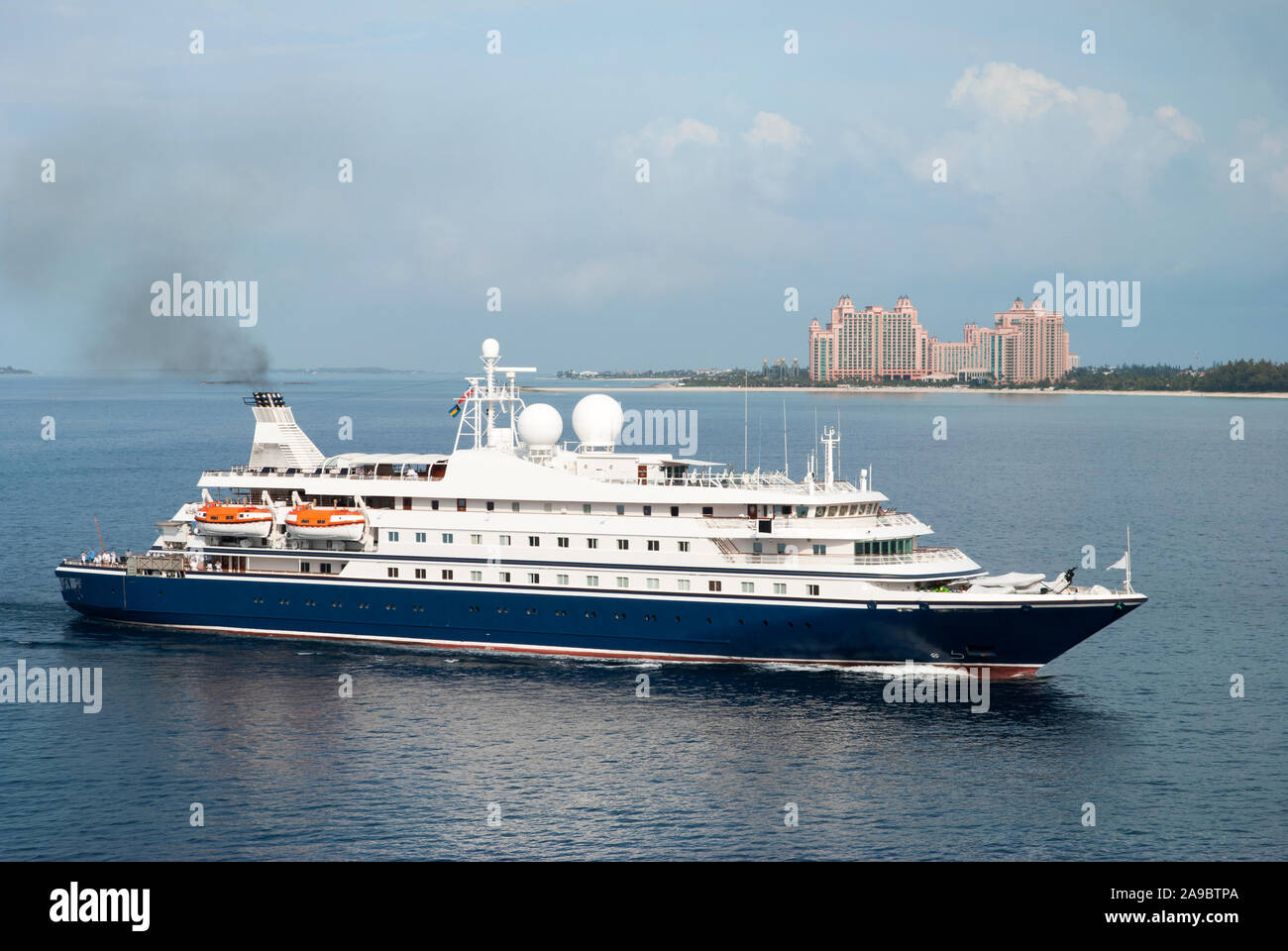 The morning view of a little cruise ship passing by Paradise Island ...