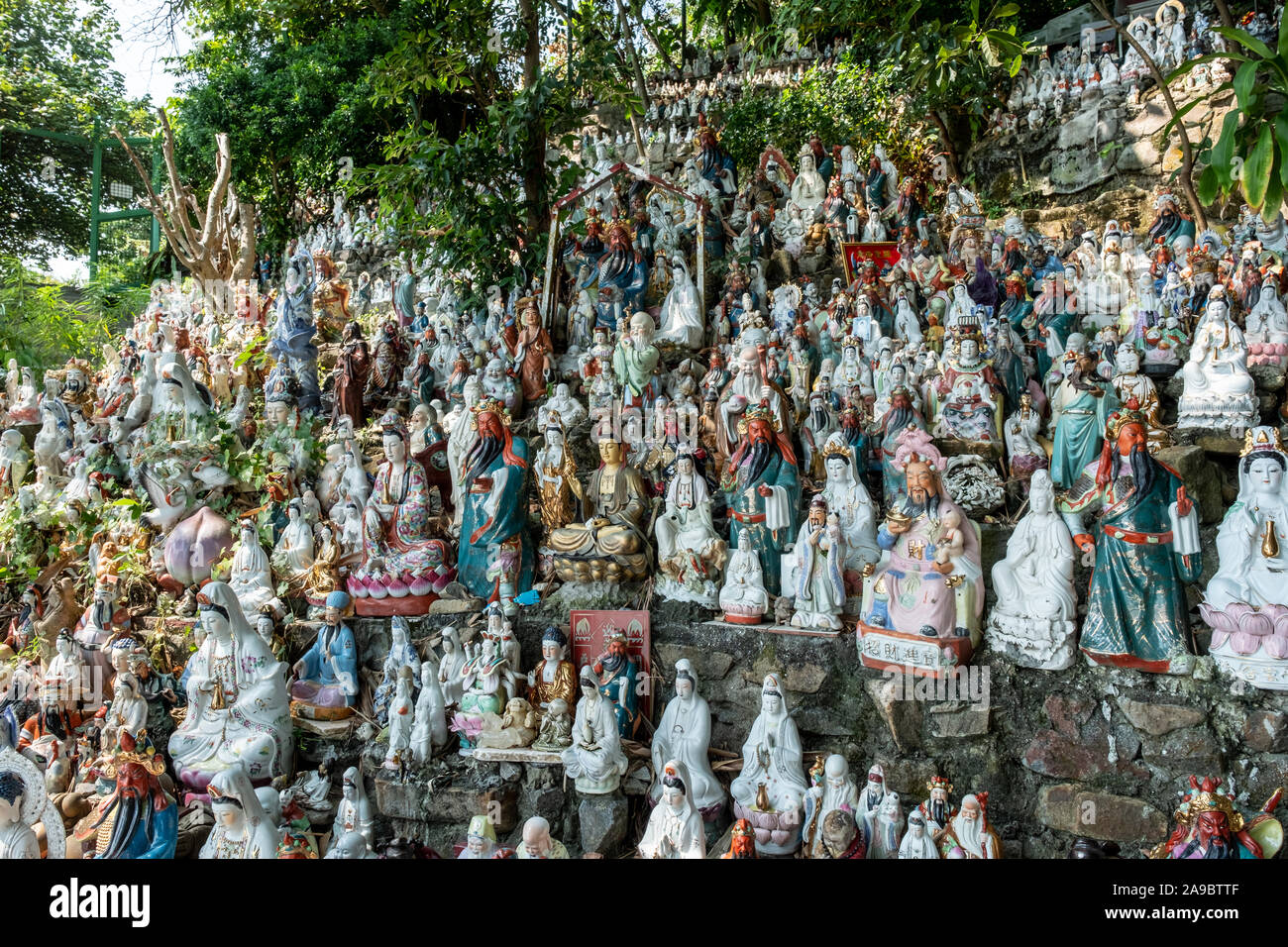 Hundreds of tiny statues depicting gods of different faiths sit along a ...