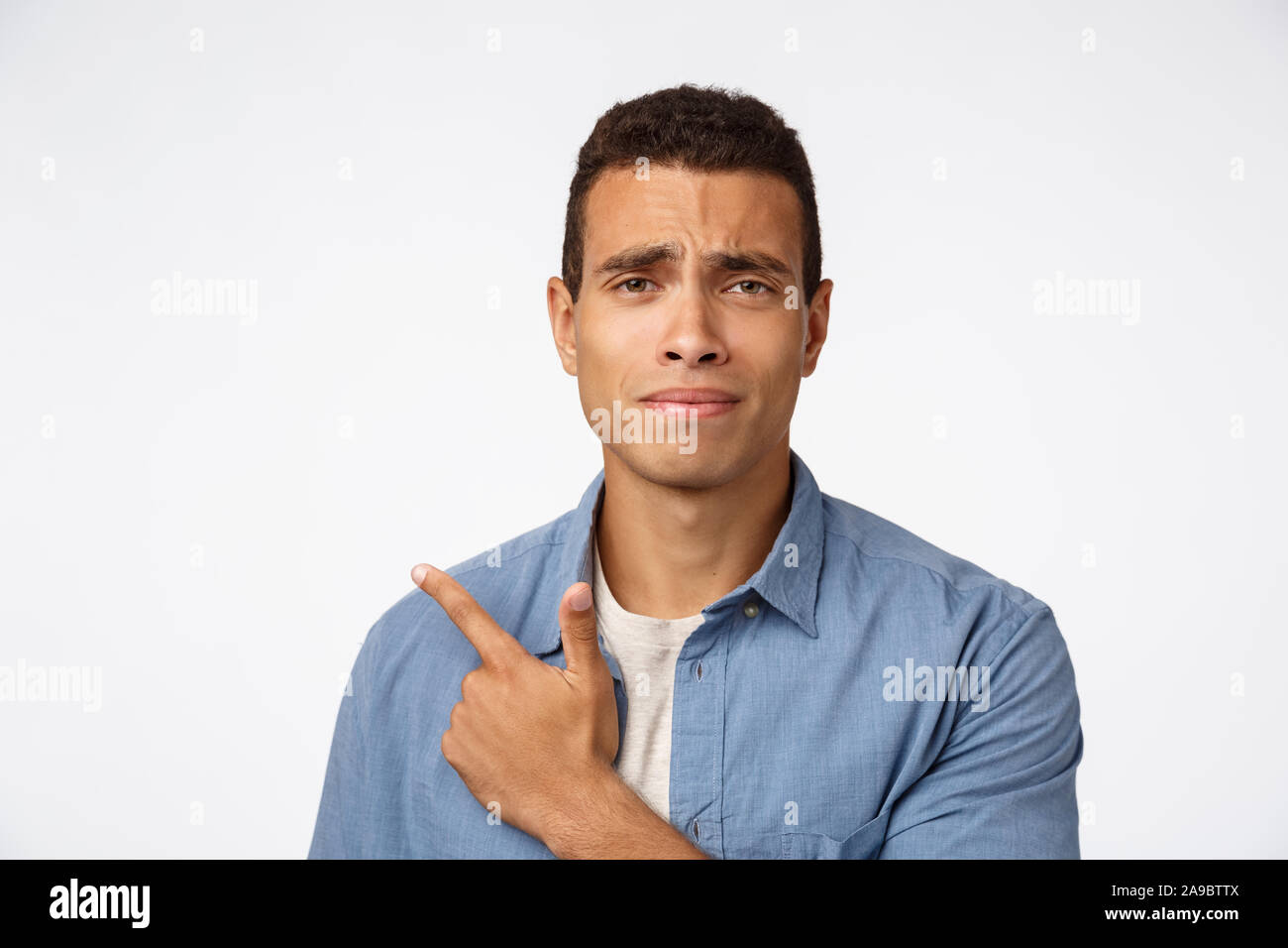 Skeptical, disappointed and doubtful handsome young man, frowning and ...