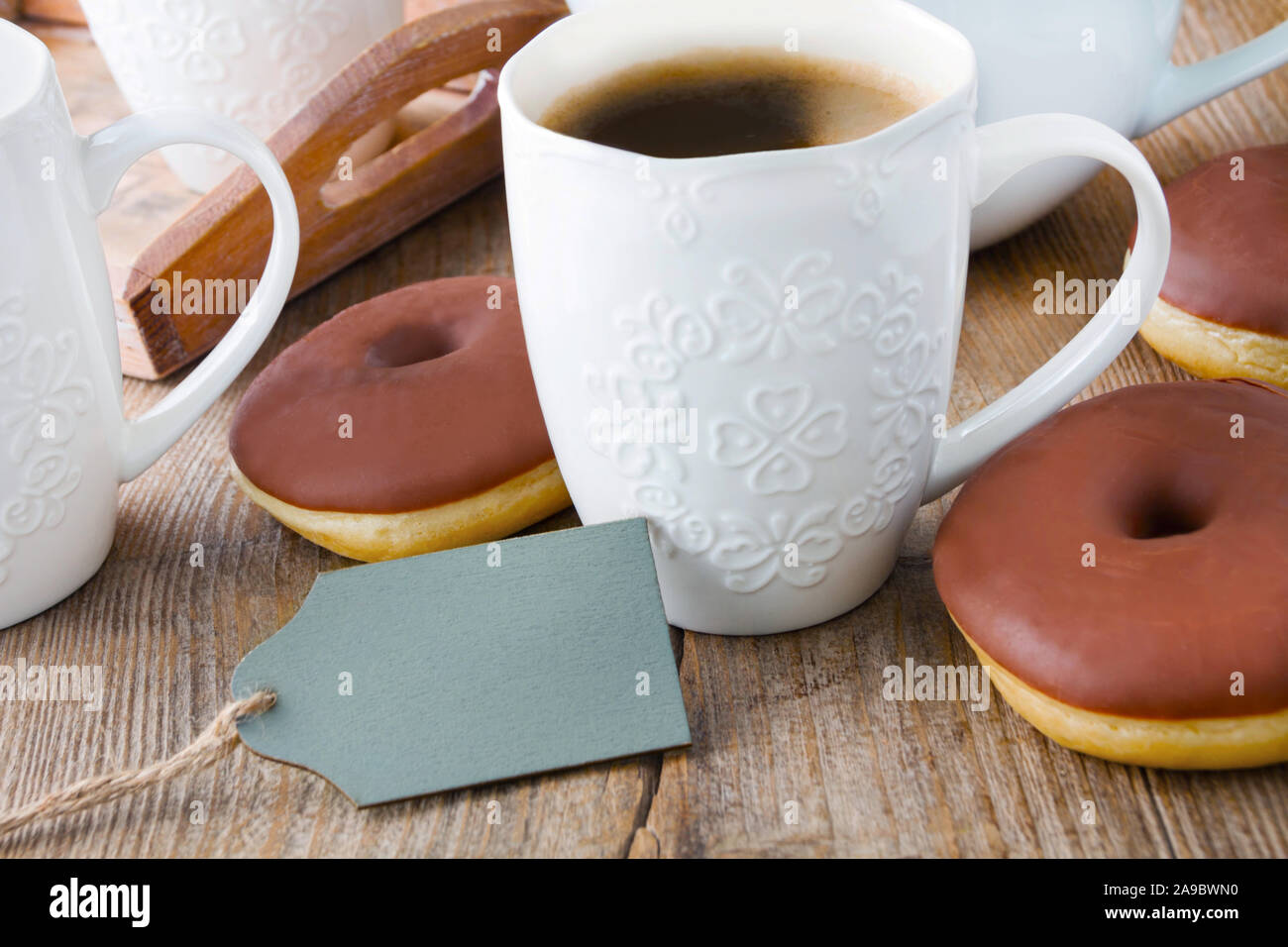 Coffee and donuts with label Stock Photo - Alamy