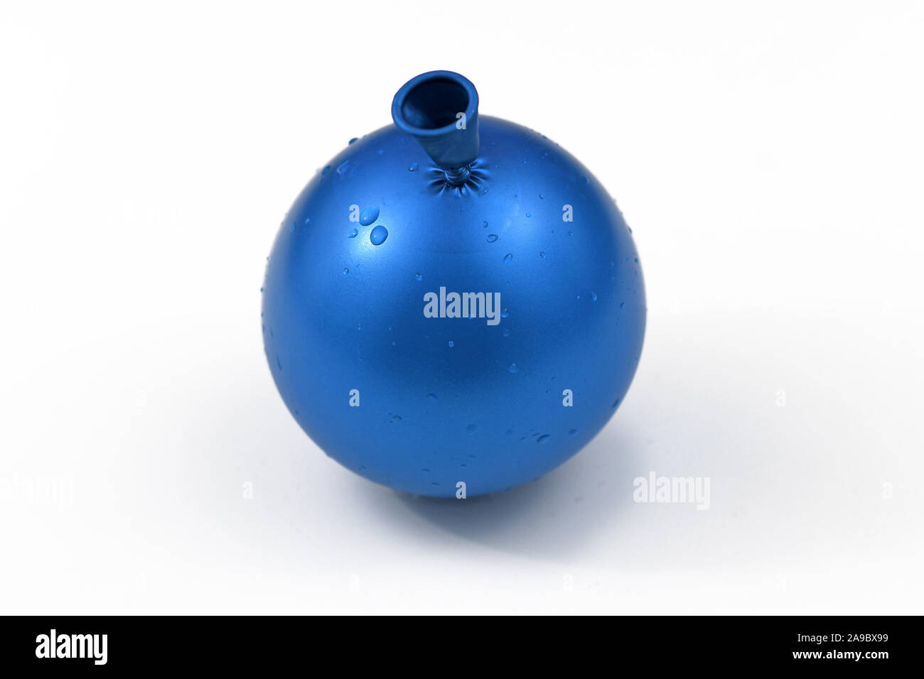 Small blue water bomb, balloon filled with water, isolated on white ...