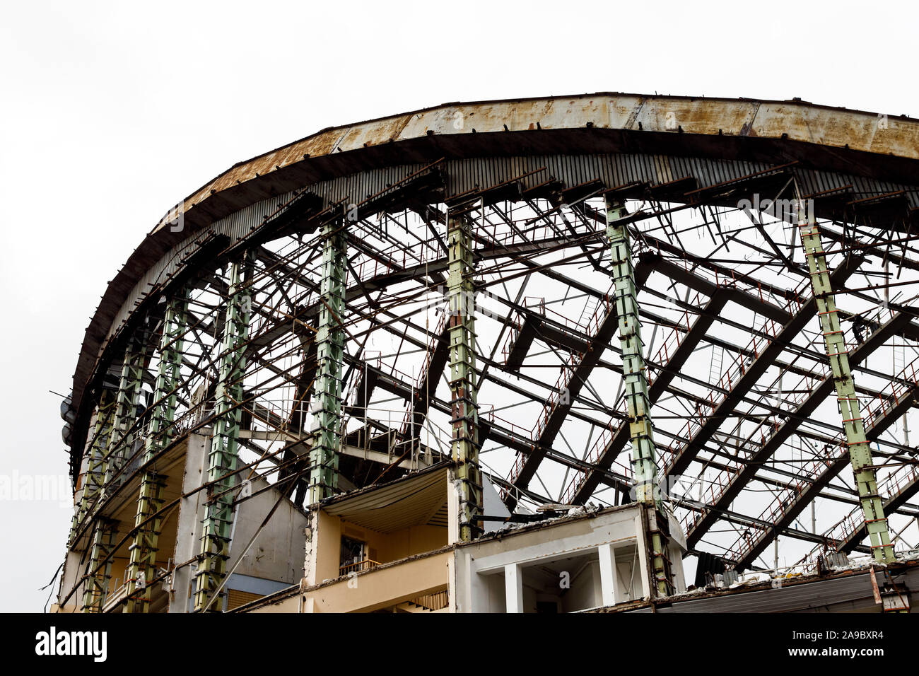 Tall dilapidated building with iron ceilings against clear sky in ...