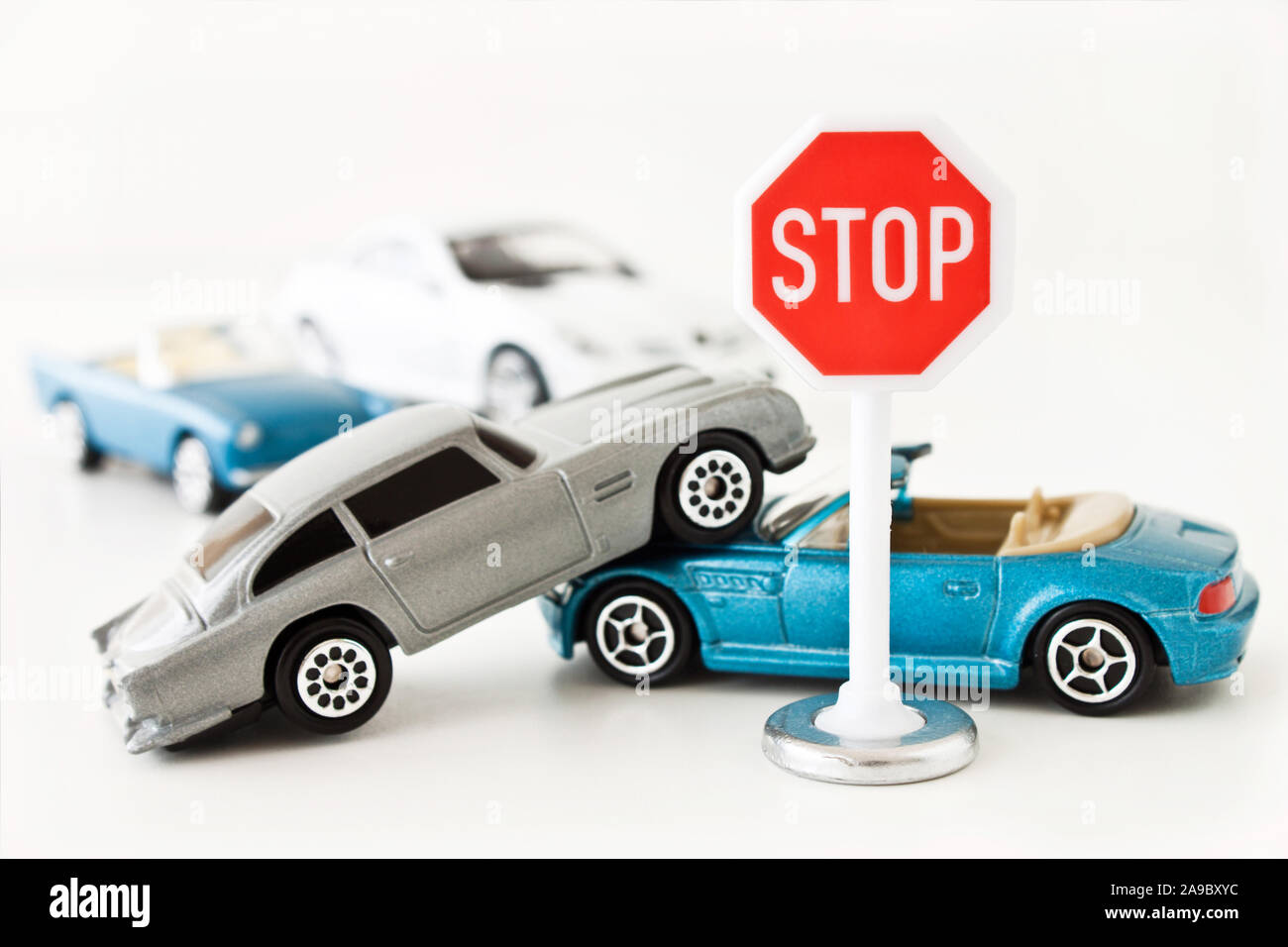Car models with stop sign on white background Stock Photo - Alamy