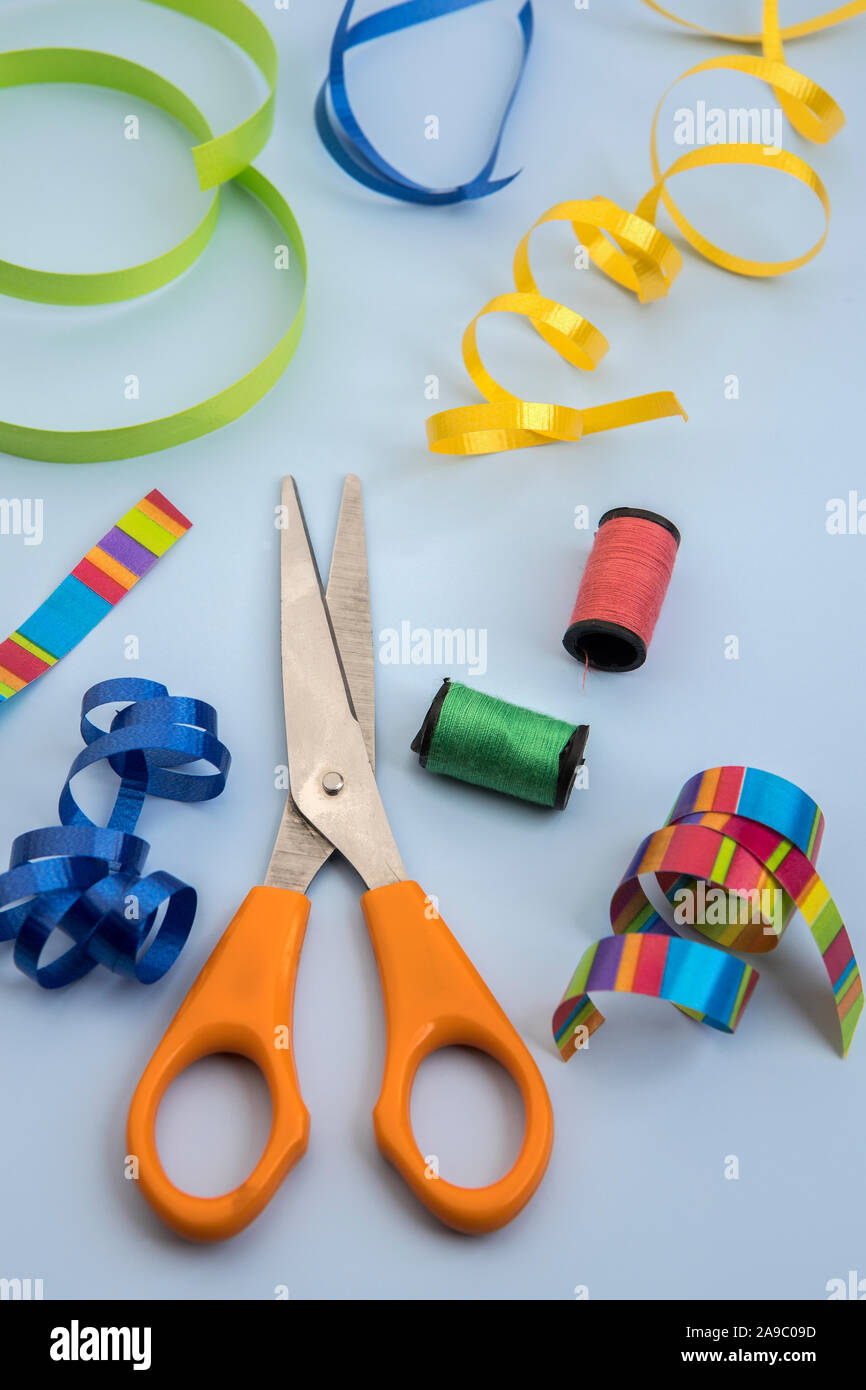 Various craft objects such as scissors, various colors of ribbons and a ...