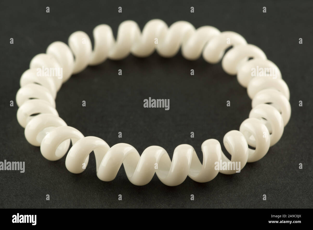 spring in the form of a white spiral for fixing hair Stock Photo - Alamy