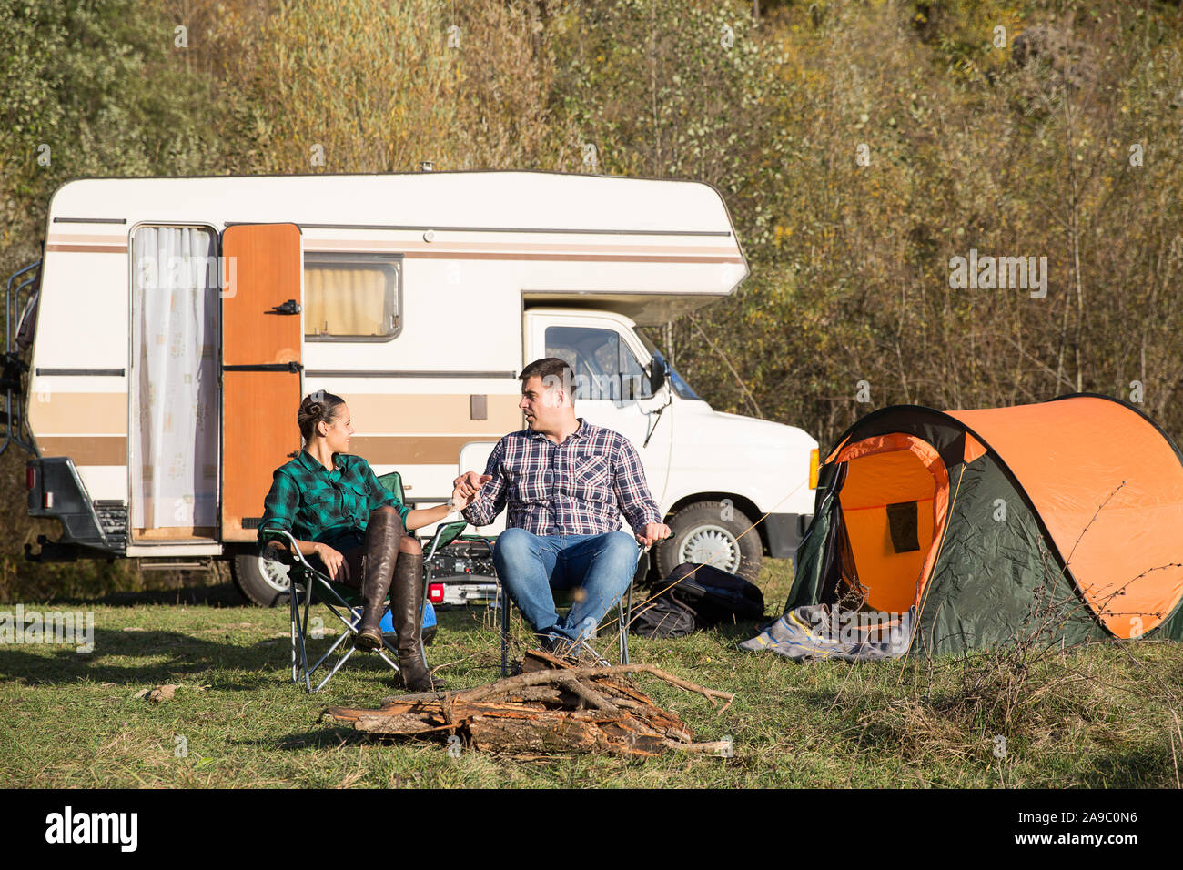 Beautiful couple camping together on a campsite in the mountains with ...