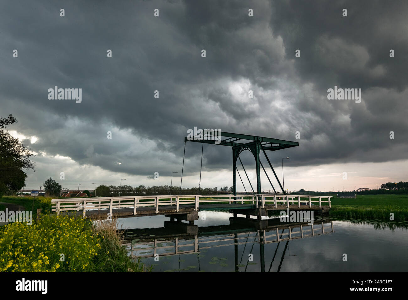 Typical dutch scene with a drawbridge over the water of a canal with an ...