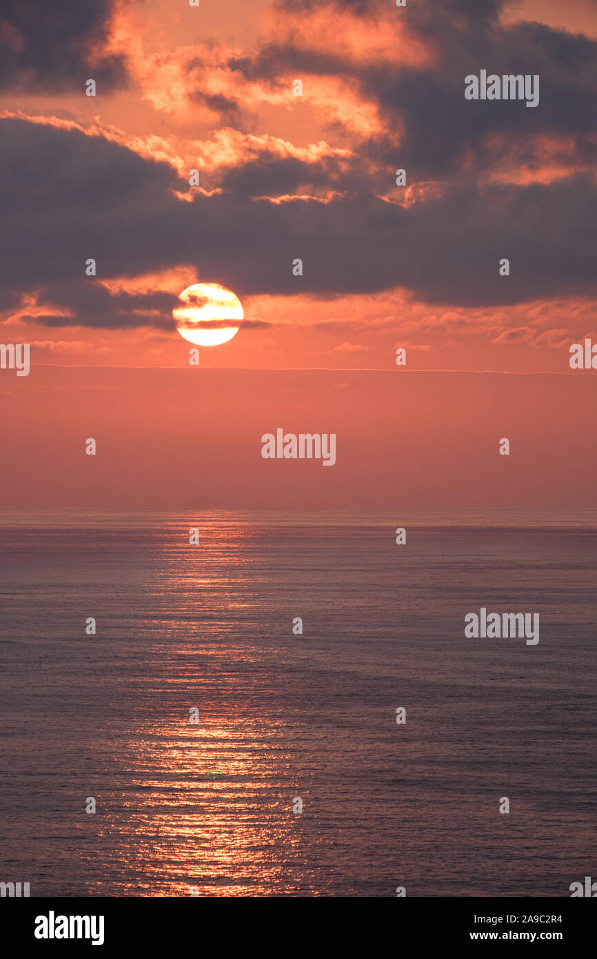 Colourful sunset over the sea , with interesting cloud formation as ...