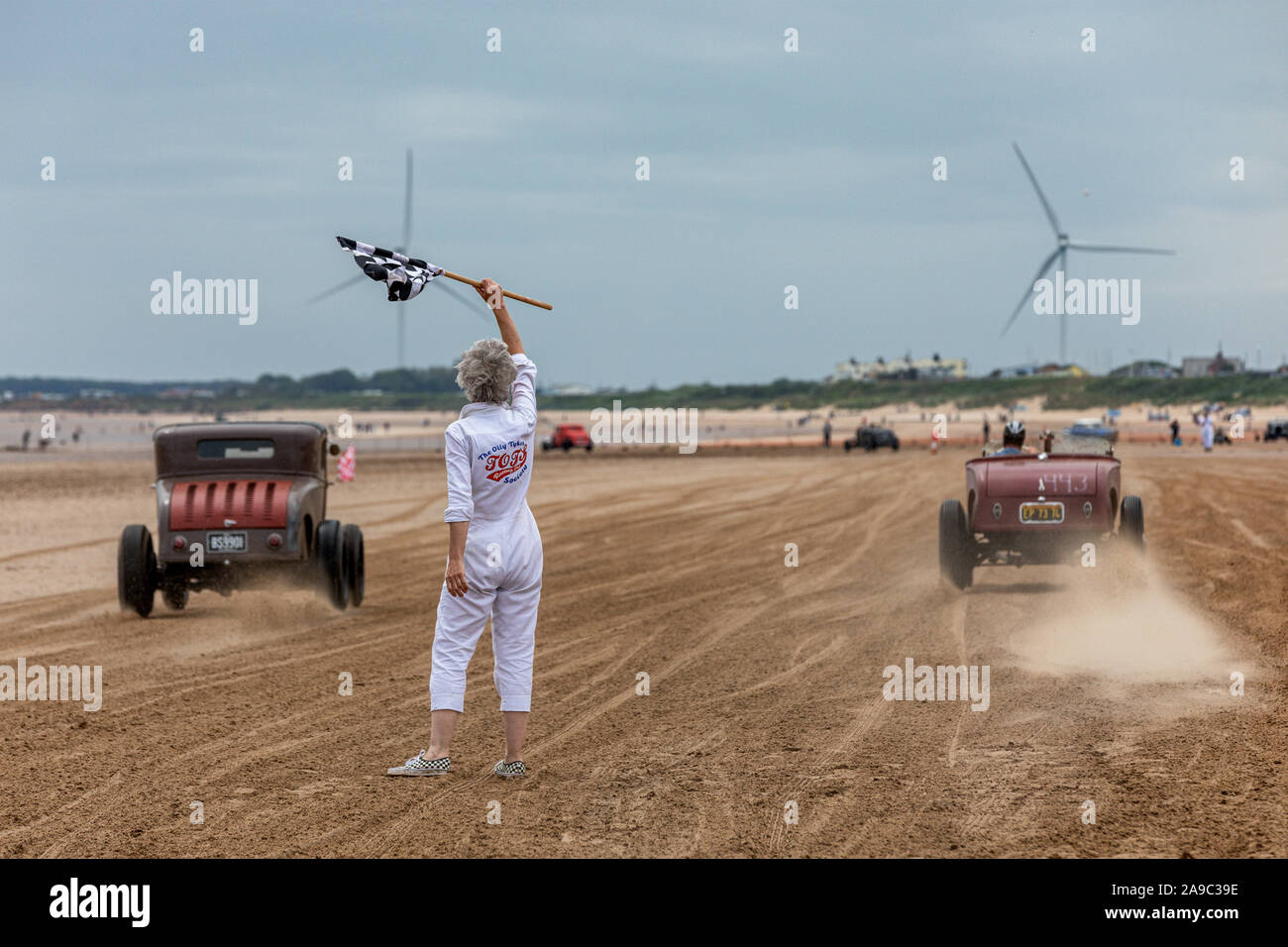 The starter gets them off at the "Race the Waves" event, where cars and ...