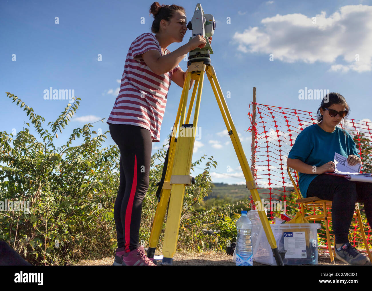 Vinča, Serbia, Sep 27, 2019: Young woman archaeologist using theodolite ...