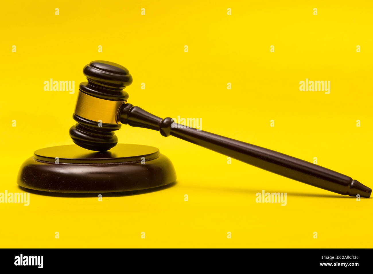Crime or justice concept showing a gavel on a yellow background Stock ...