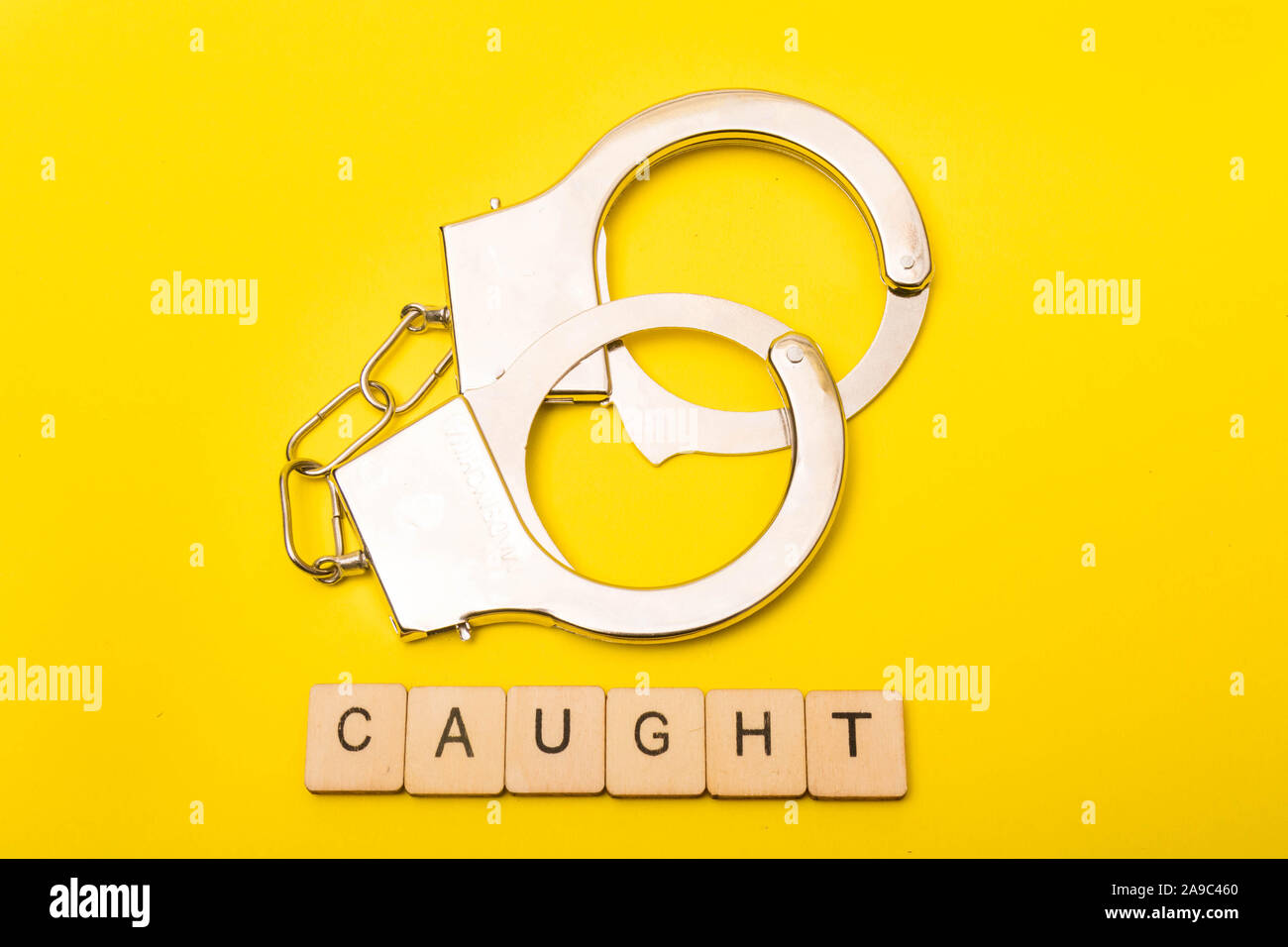 Crime or justice concept showing a sign reading caught on a yellow ...