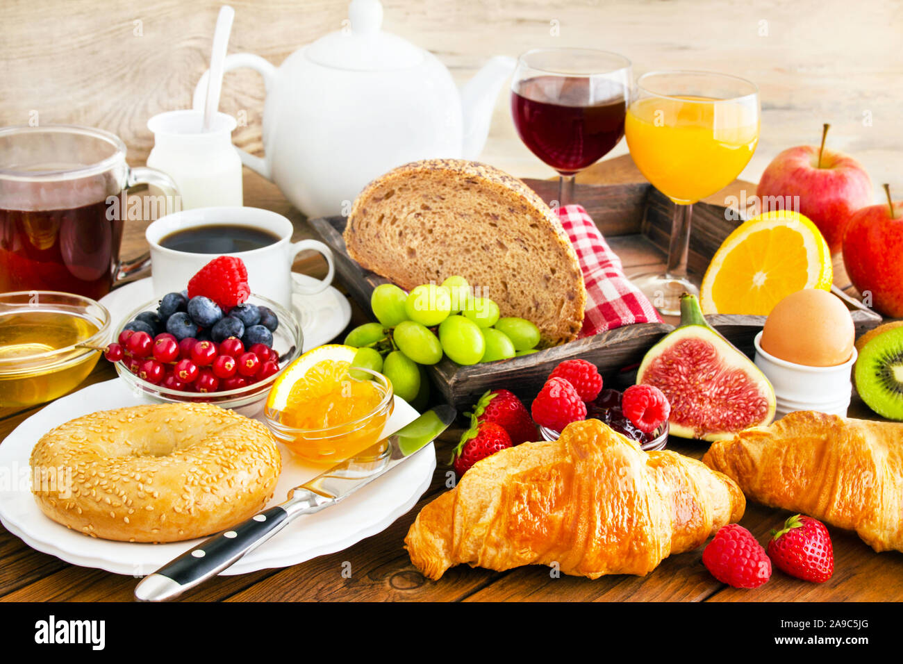 Breakfast table with bread and fruits with beverages Stock Photo - Alamy