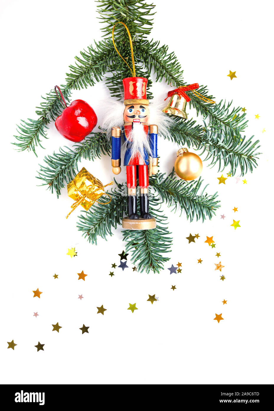 Christmas decorations and tree branch on white background. Striped ...