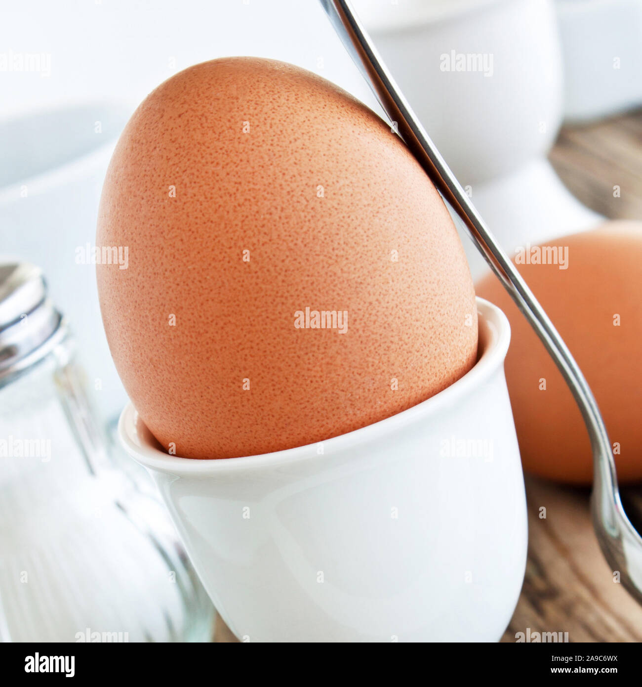 Boiled egg and spoon close up Stock Photo - Alamy