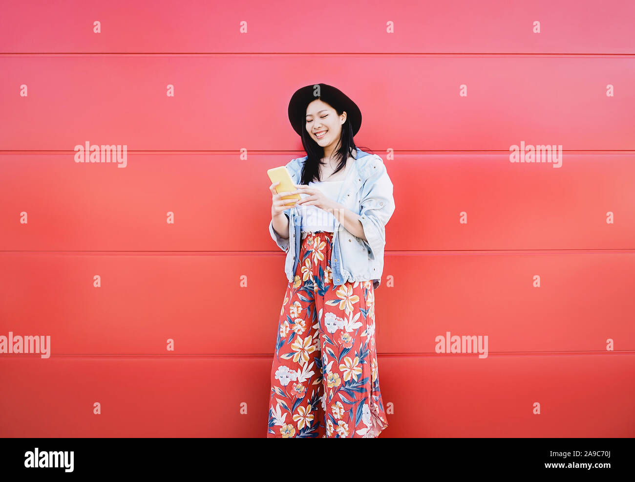 Happy Asian girl using mobile phone outdoor - Chinese social influencer ...