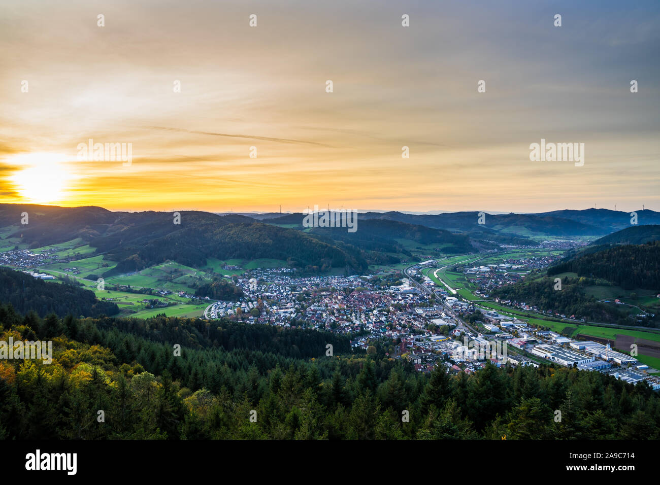 Germany, Romantic orange sunset sky decorating beautiful view over tree ...