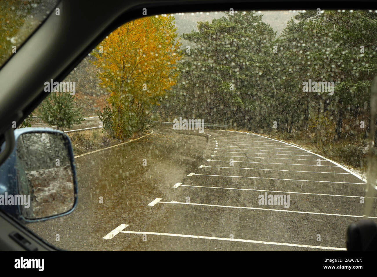 The view of a wintry forest car park through the window of a camper van ...