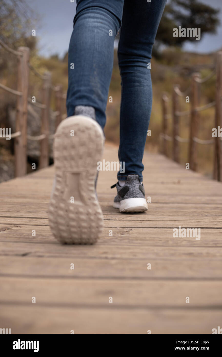 Runner feet running on wood bridge closeup on shoe. Selective focus ...