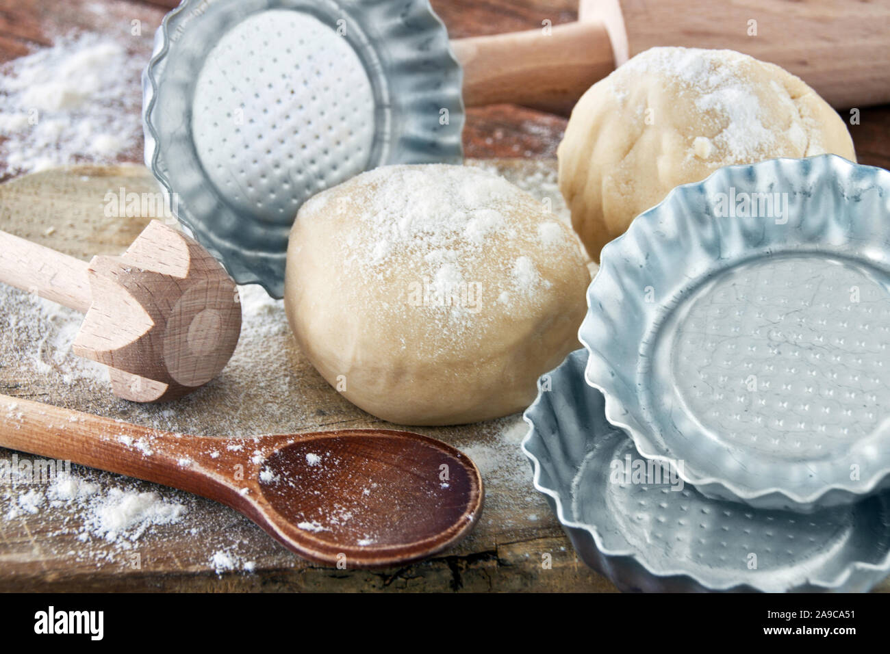 Baking forms and dough in the kitchen Stock Photo - Alamy