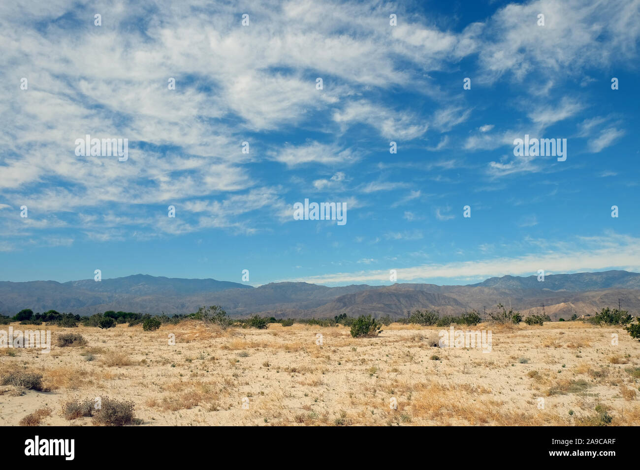 Sandy Desert Landscape with Mountains, Blue Sky, and Clouds Stock Photo ...